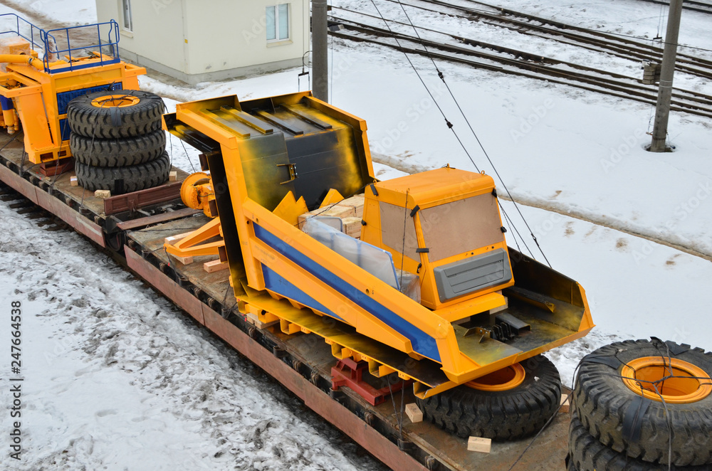 Yellow mining truck disassembled into parts, cab, body, electric motor ...