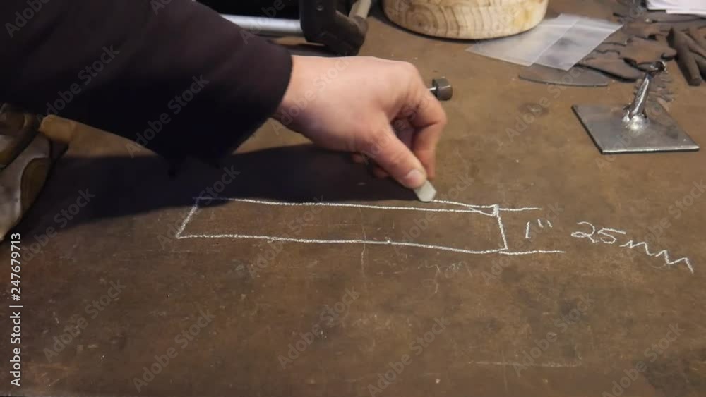 Man Drawing a Diagram in Soapstone on a Metalworking Workshop Work ...