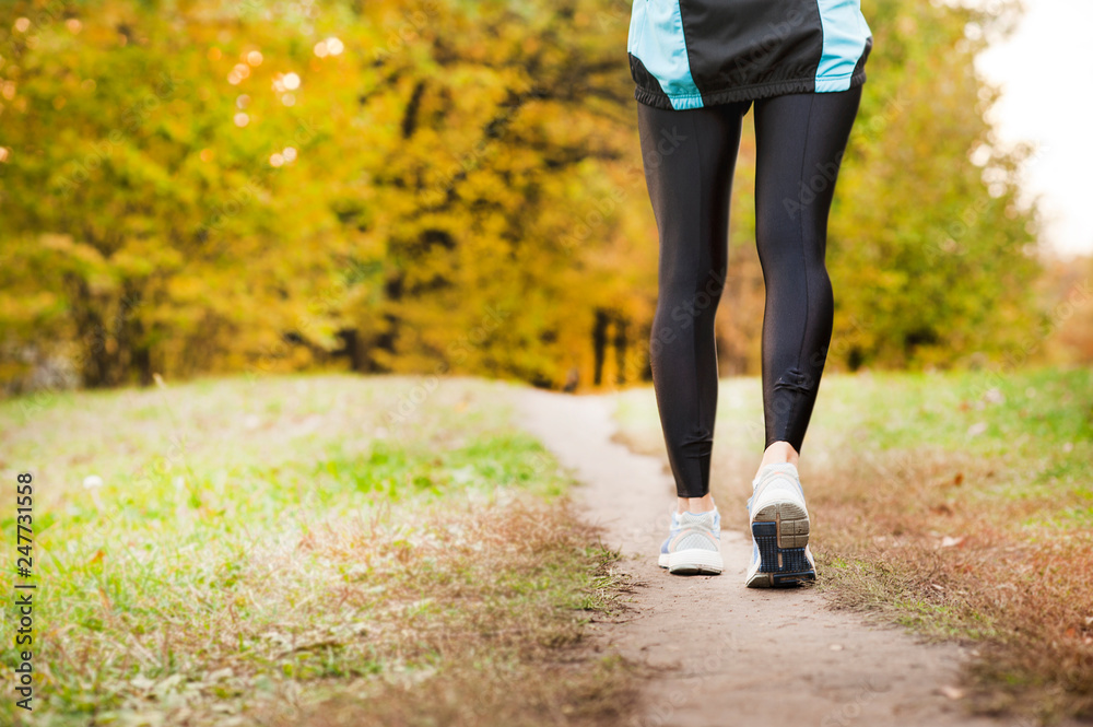 running along a park path, healthcare and problem concept - close-up of ...