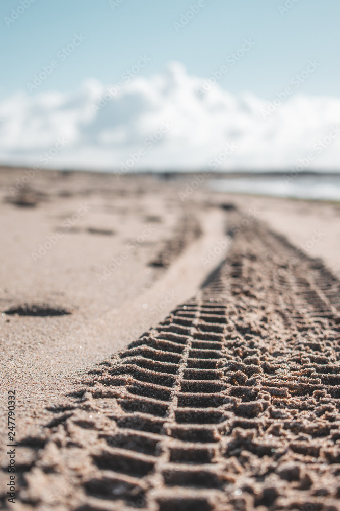 Leading sand tracks tyre trail on a beach in the Netherlands ...