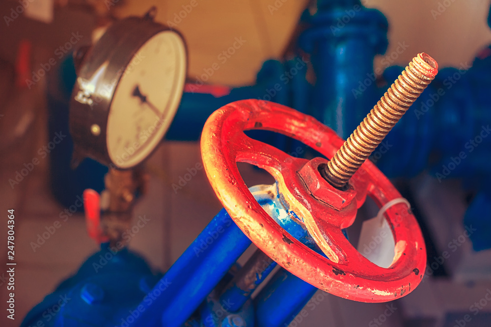 Red gas valve and pressure gauge with an arrow on the limit. Background ...