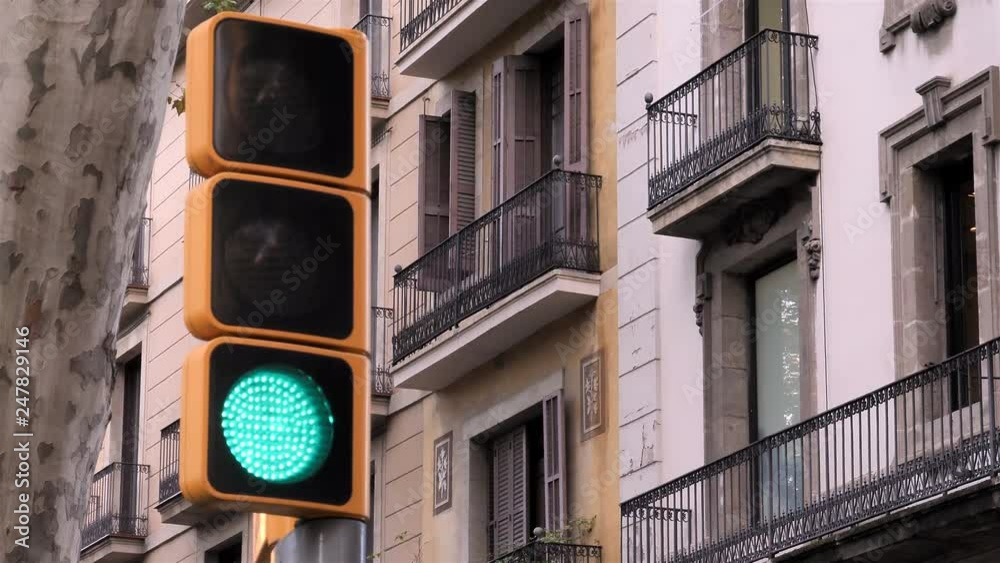 Yellow and green modern traffic light in town. Urban cityscape in ...