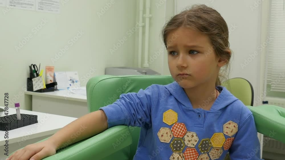 Blood test, little girl sitting on medical chair while nurse taking her ...