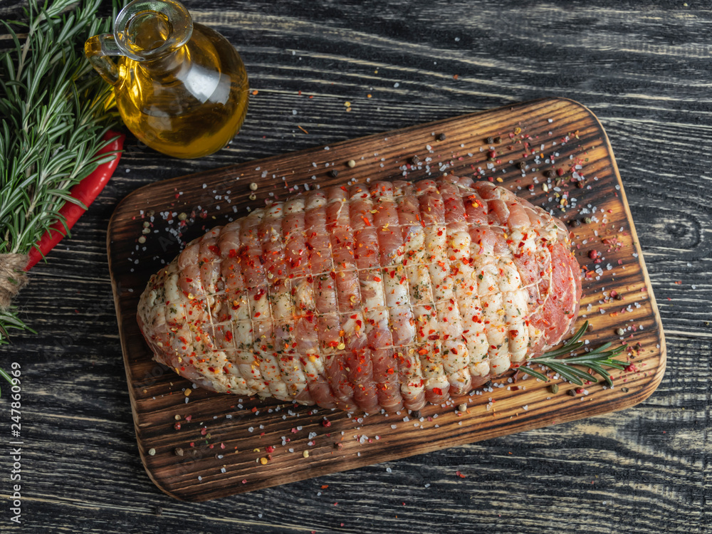 Raw pork roulade. Raw rolled meat enclosed in tied netting. Meat pulp ...