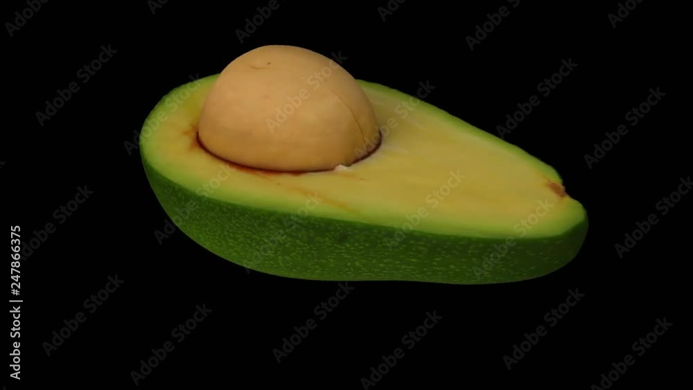 Realistic render of a rotating green Florida avocado (cut in half with ...
