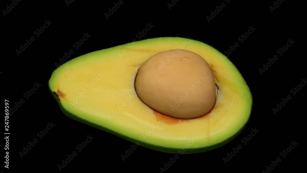 Realistic render of a rotating green Florida avocado (cut in half with ...