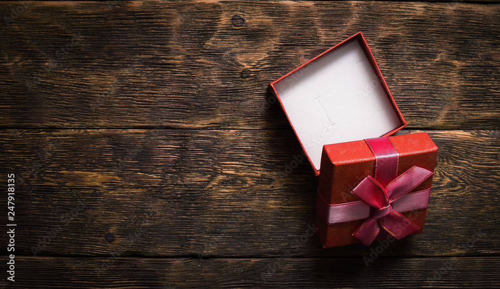 Open square empty gift box on aged brown wooden table background with ...