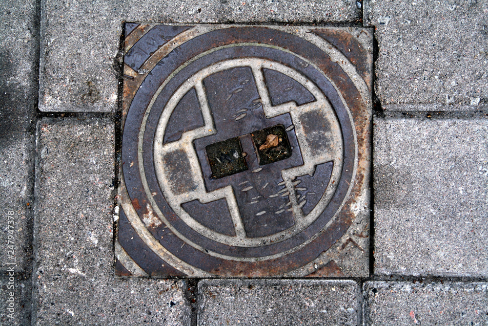 Scandinavian manhole in its urban surrounding. Hidden beauty in design ...