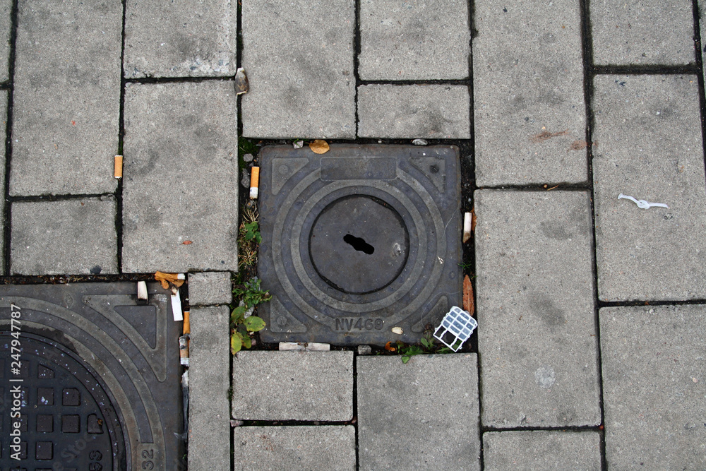 Scandinavian manhole in its urban surrounding. Hidden beauty in design ...