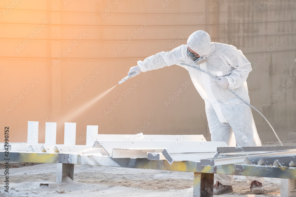 Poster worker painting a mechanical part with airless spray – Wall Art ...