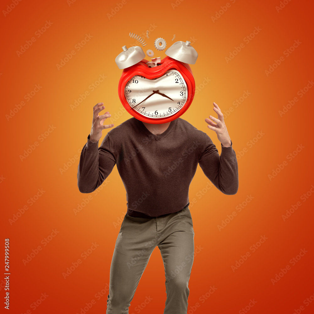 A man in a casual outfit standing and raising hands in an angry gesture ...