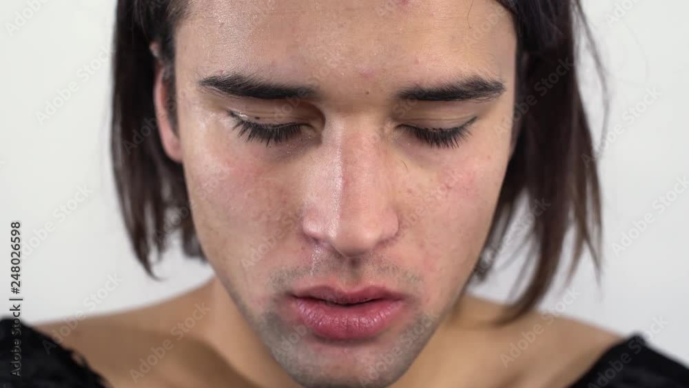 Close-up on the face of a sad guy with dripping mascara. Concept of ...