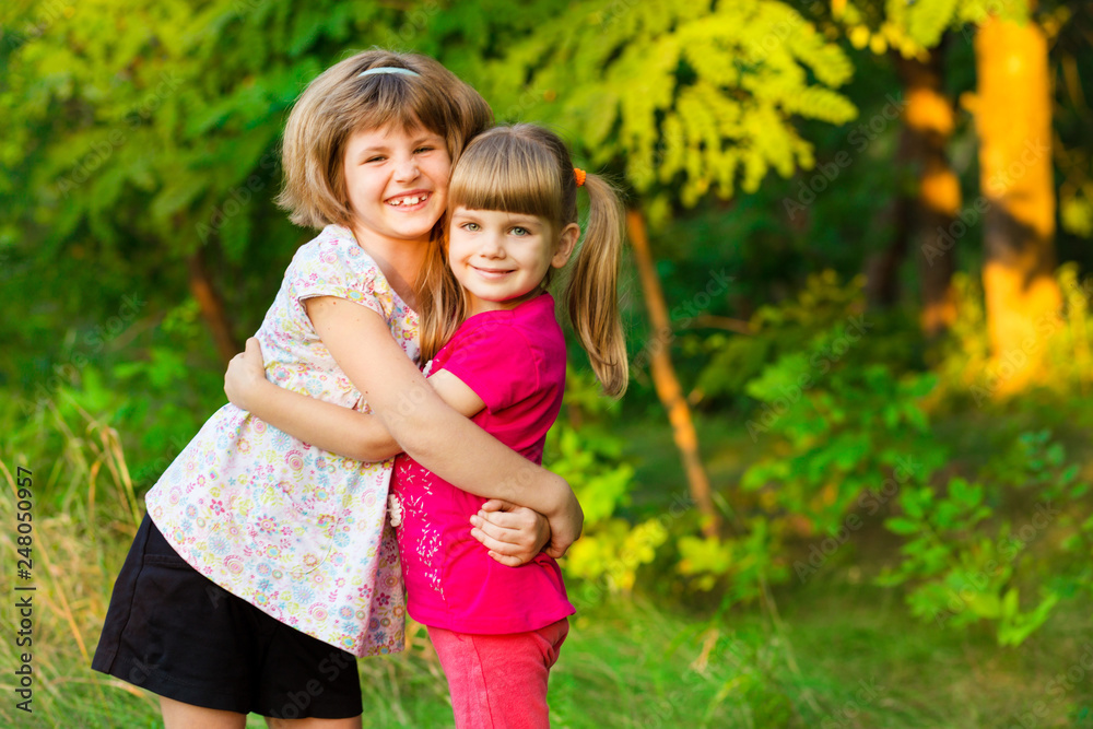 Two Little Sisters Hugging