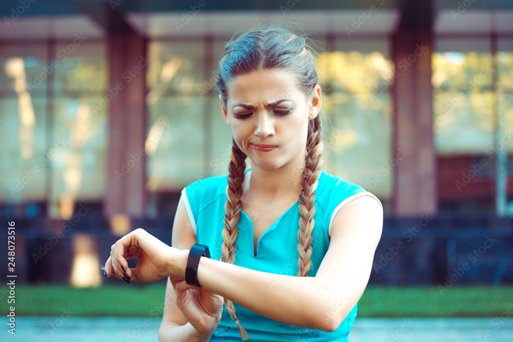 Sad unhappy young sports woman dressed in blue shirt sportswear ...