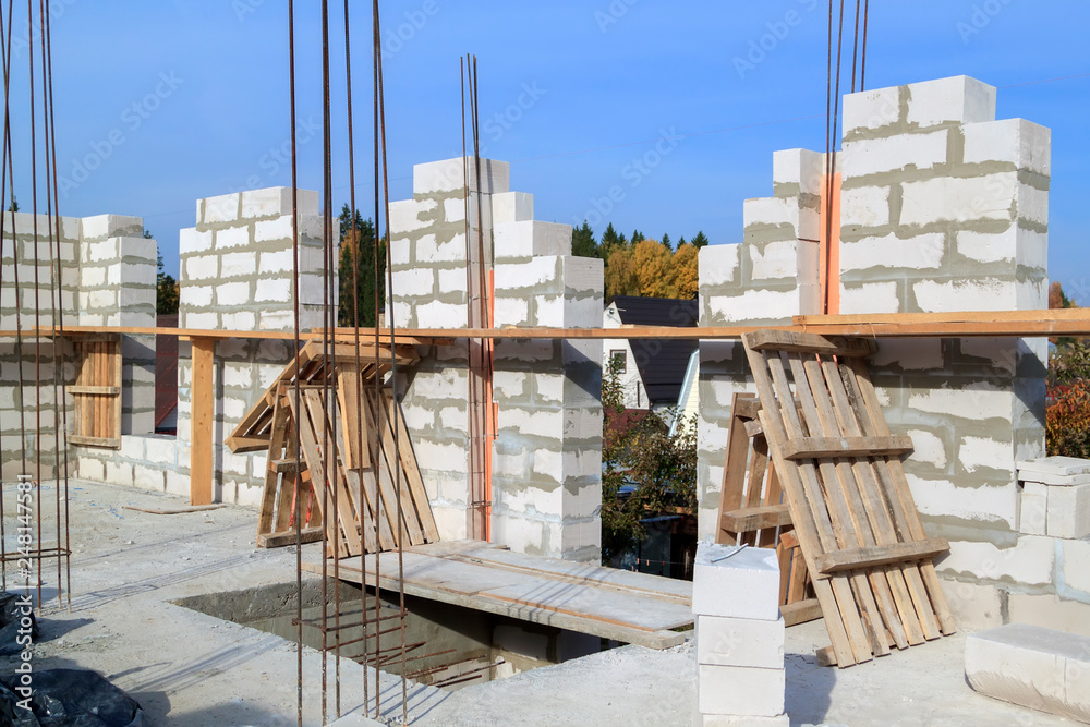 view of laying walls of first floor, fittings for filling supporting ...