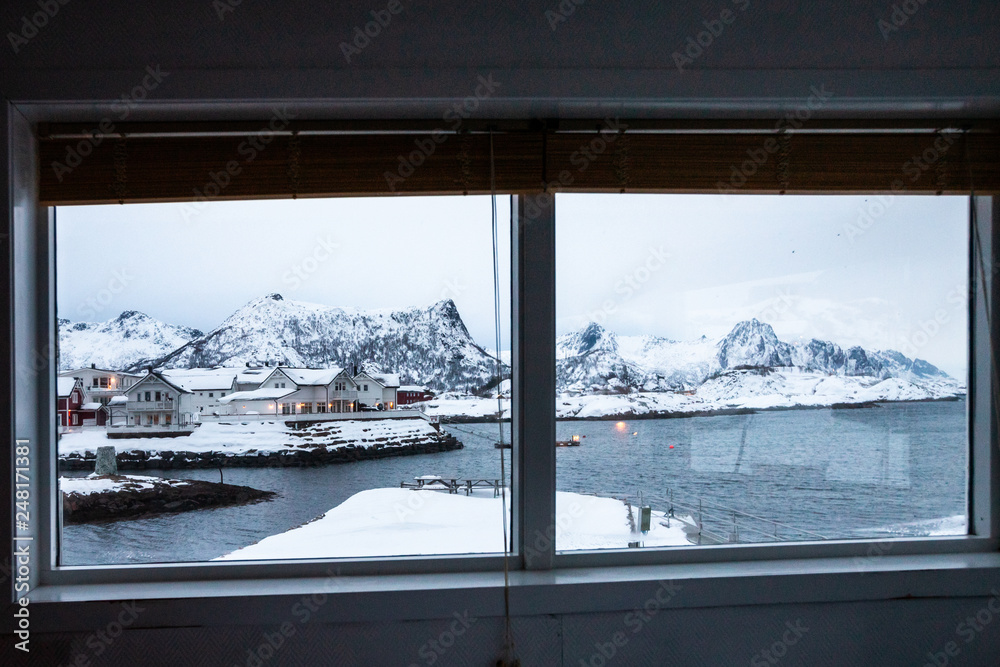 port of Kabelvag seen through the window of a house, Lofotten Islands ...