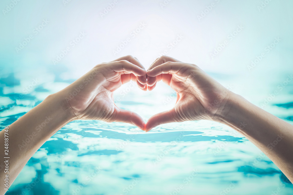 Hands in love heart shape for friendship and saving water and ocean ...