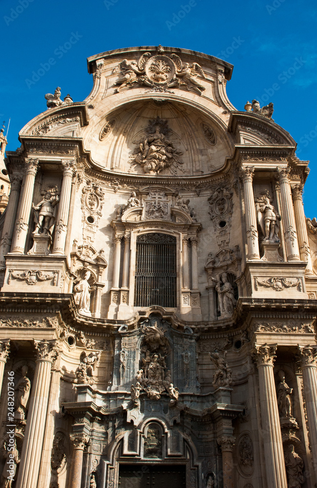 Part of facade of catholic cathedral with columns and sky in Spain ...