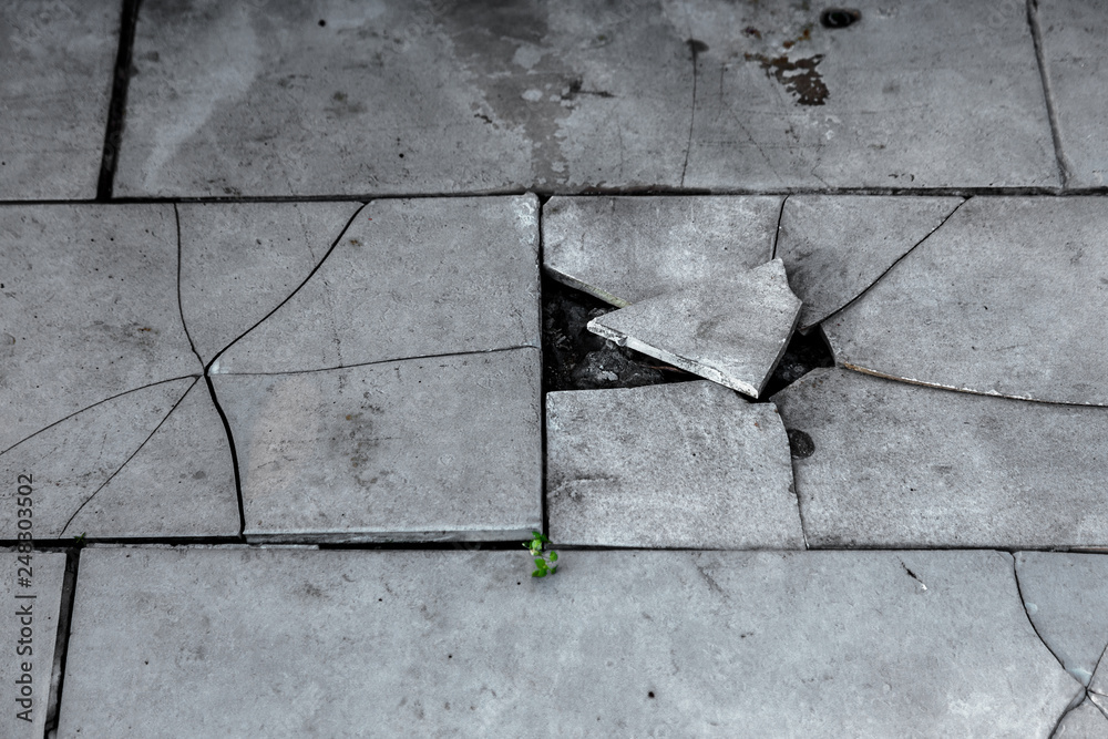 Bad road, damaged by rain and snow, needs repair. Broken asphalt ...