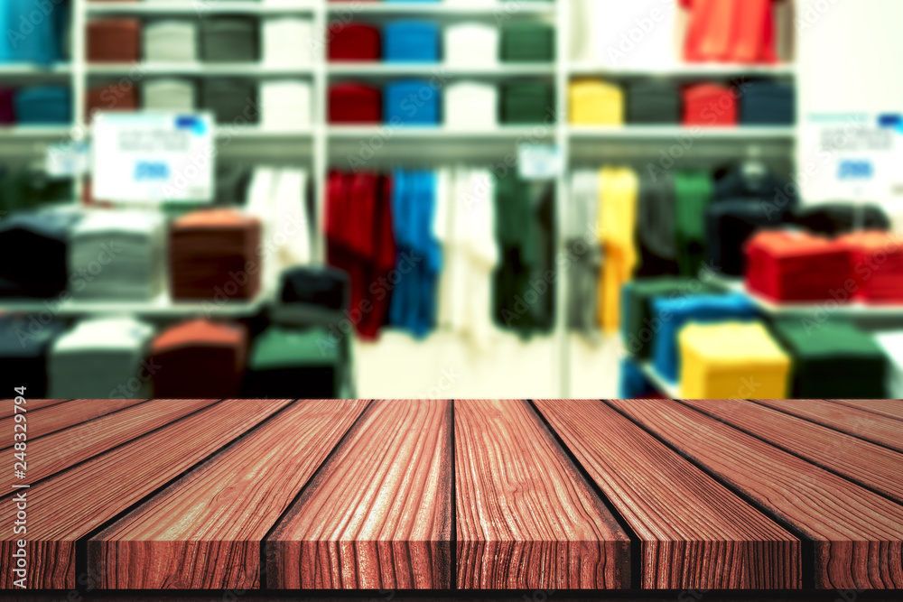 Wooden table with blurry background of casual boutique shop, shirt ...