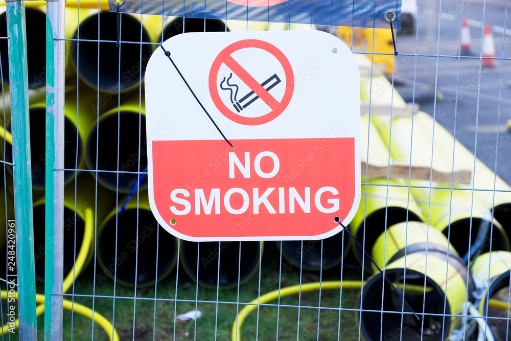 No smoking construction safety sign and yellow gas pipe for external ...