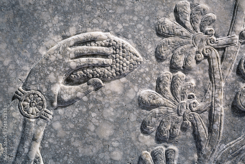 Assyrian wall relief of a genius, detail with a cone in a hand Stock ...