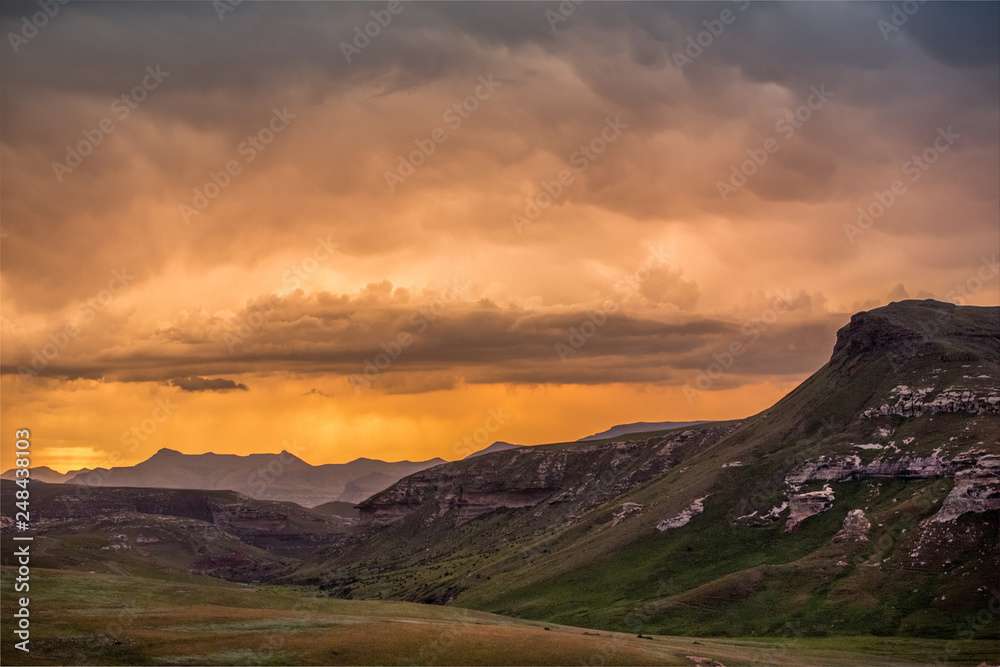 Cliffs and mountains under dramatic colorful storm clouds at sunset ...