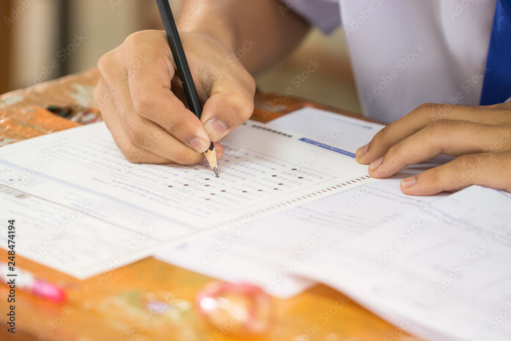Foto de School / university Students hands taking exams, writing ...