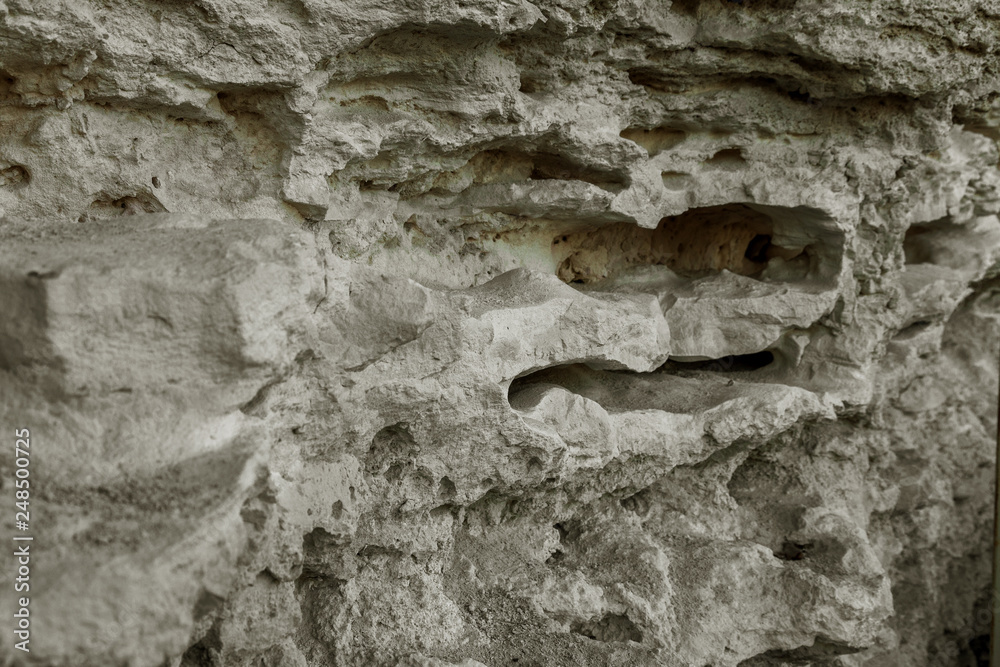 Picturesque background of collapsing surface of limestone rock ...