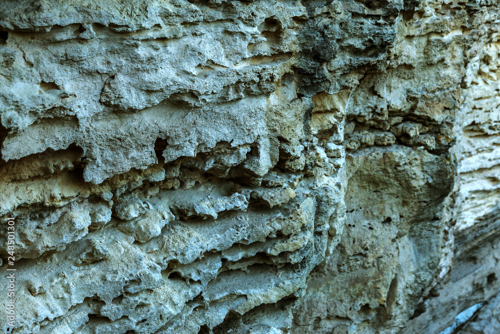 Picturesque background of collapsing surface of limestone rock ...
