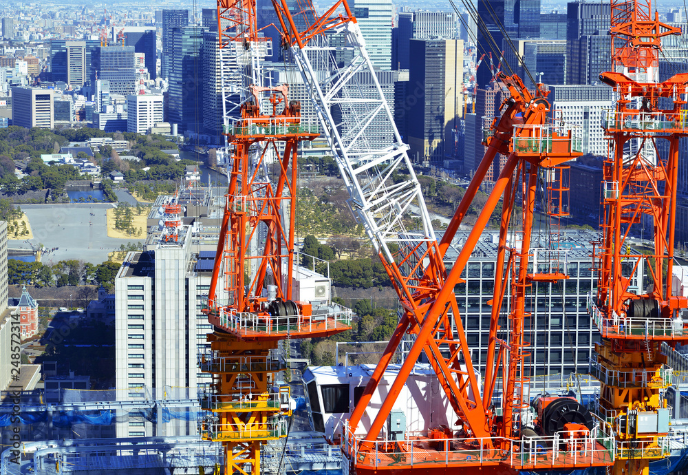 Tower Cranes on top of skyscraper with city background, a popular sight ...