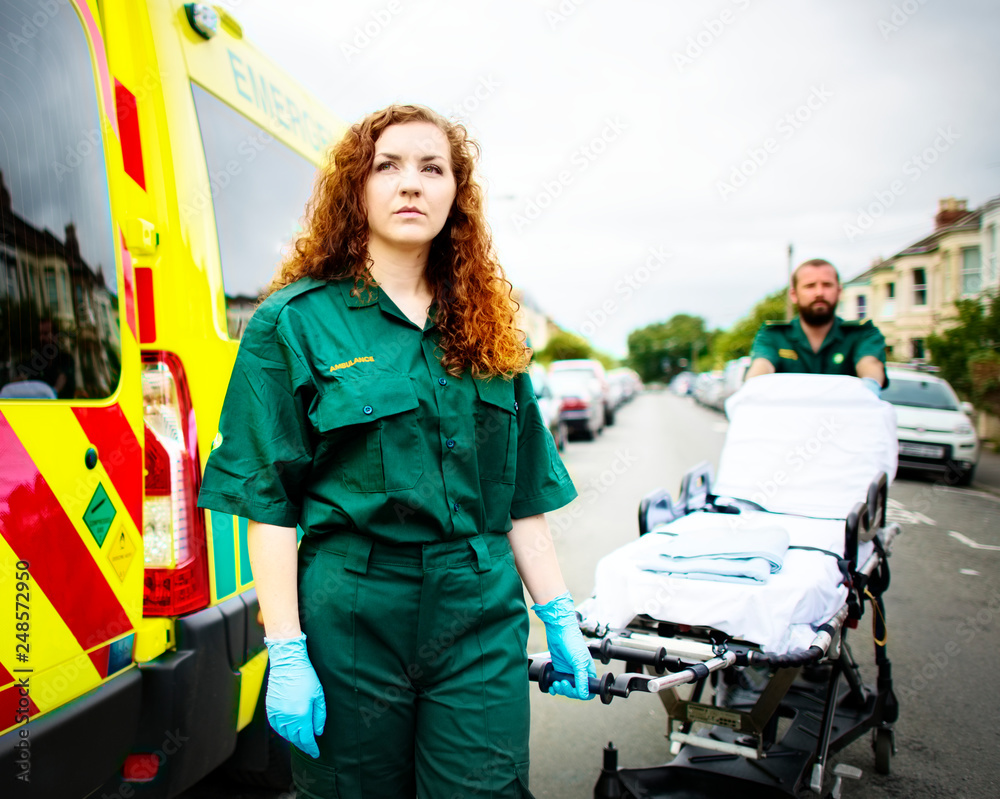 Paramedics rolling the ambulance stretcher Stock Photo | Adobe Stock
