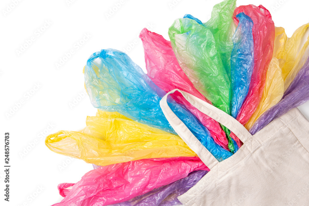Many single use plastic bags in one eco natural reusable shopping bag ...