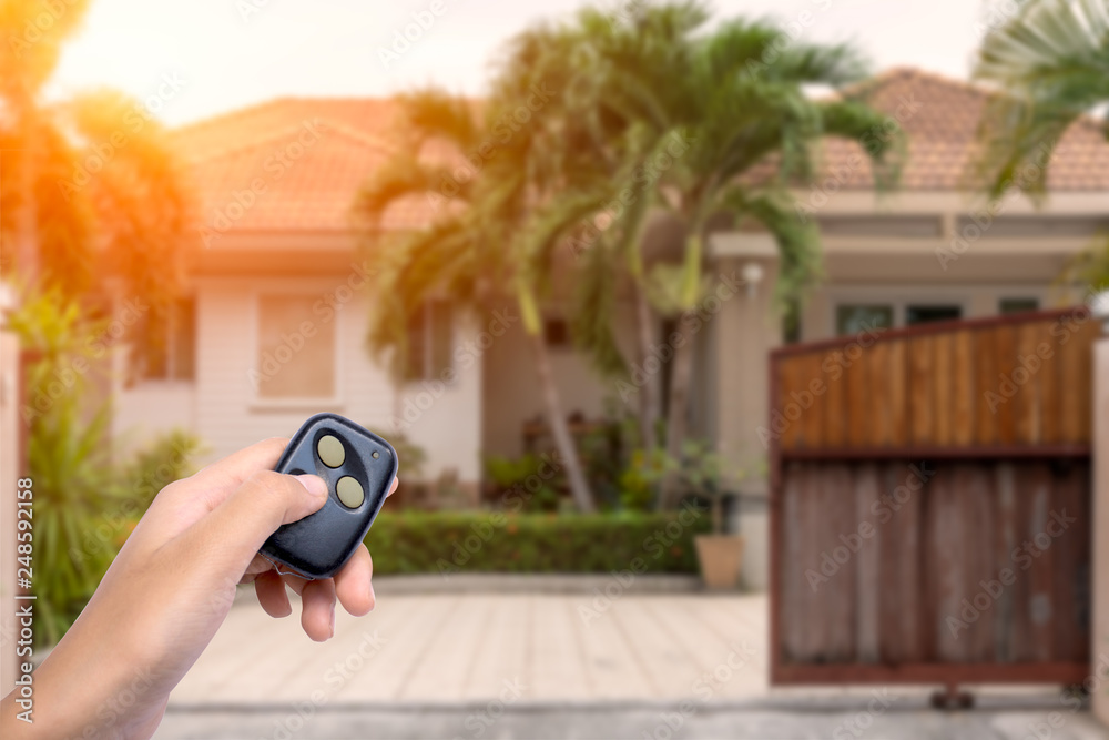 Mockup female hand holding and pressing remote control to open or close ...