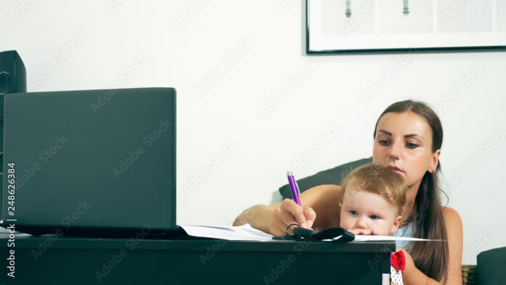 Female freelance job concept. Modern motherhood. Working mother with a ...