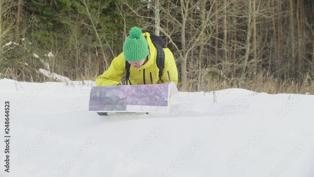 Woman ecologist marking something on the map, then walking along the ...