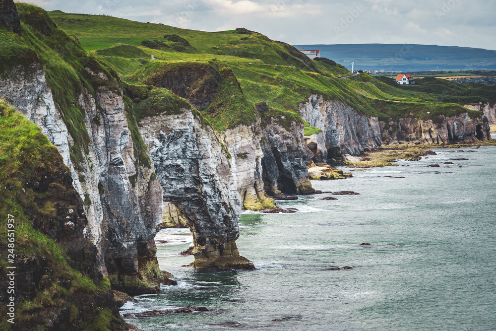 Close-up green covered cliff. Northern Ireland shoreline. Overwhelming ...