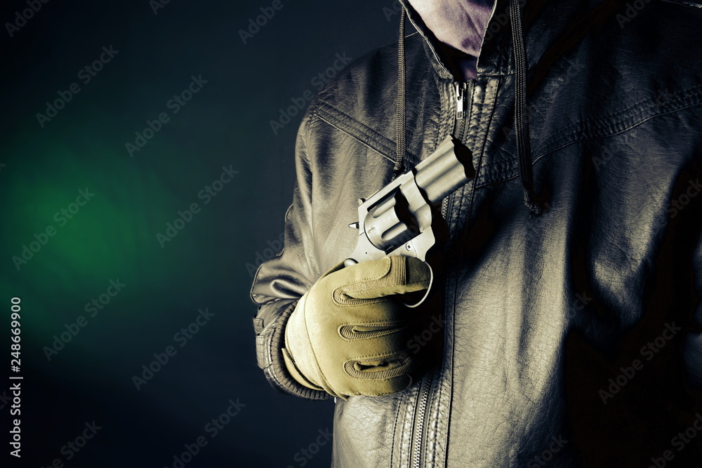 Dangerous criminal hold gun in hand.Large revolver ready for robbery or ...