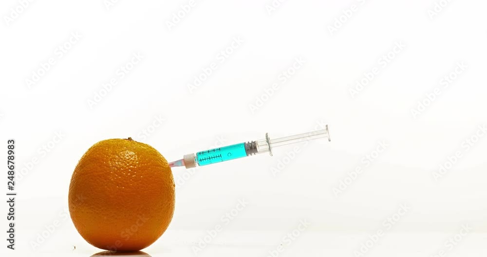 Syringe injecting Treatment into Orange, citrus sinensis, Fruit against ...