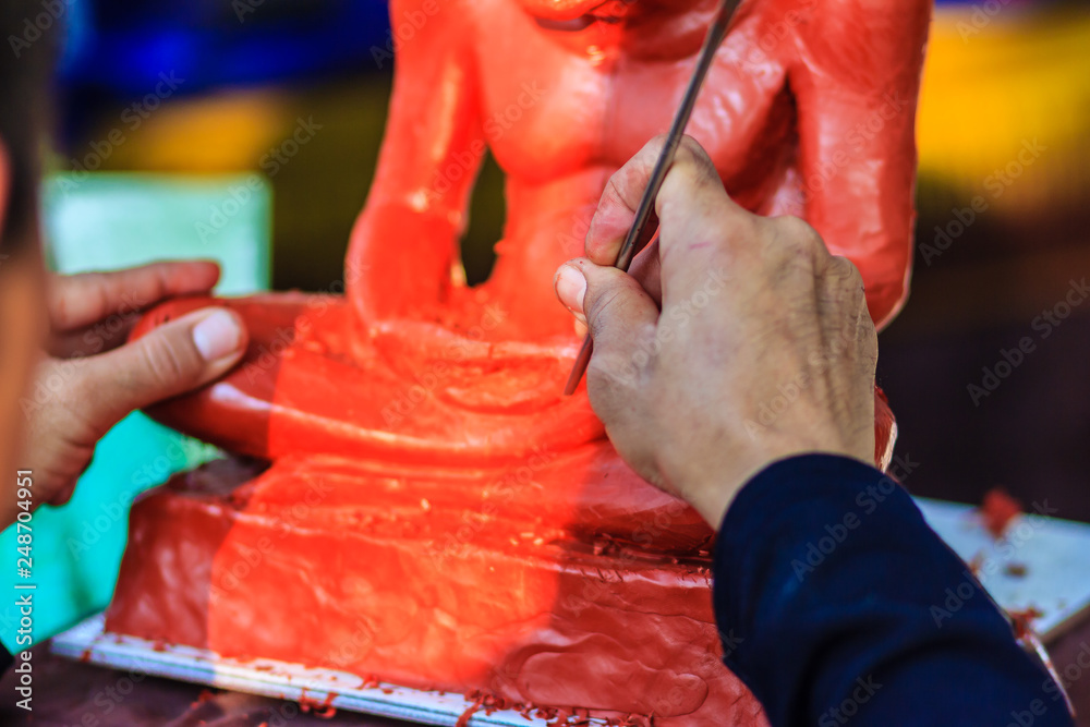 Sculptor carving the clay monk image. Thai sculpture artist molding and ...