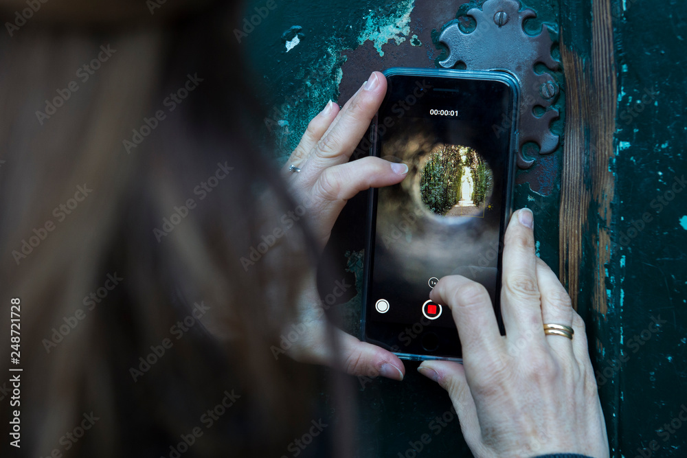 Rome, February 07, 2018: A tourist takes a pictures of St. Peter's dome ...