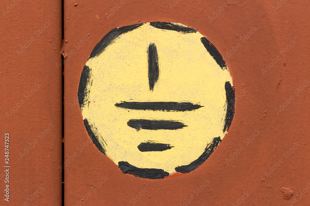 Eectric ground hazard warning sign symbol on a painted metal surface ...