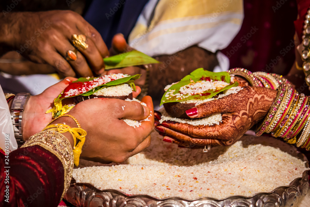Foto de Bride and Groom Offer Rice as a Symbol of Plenty at a South ...