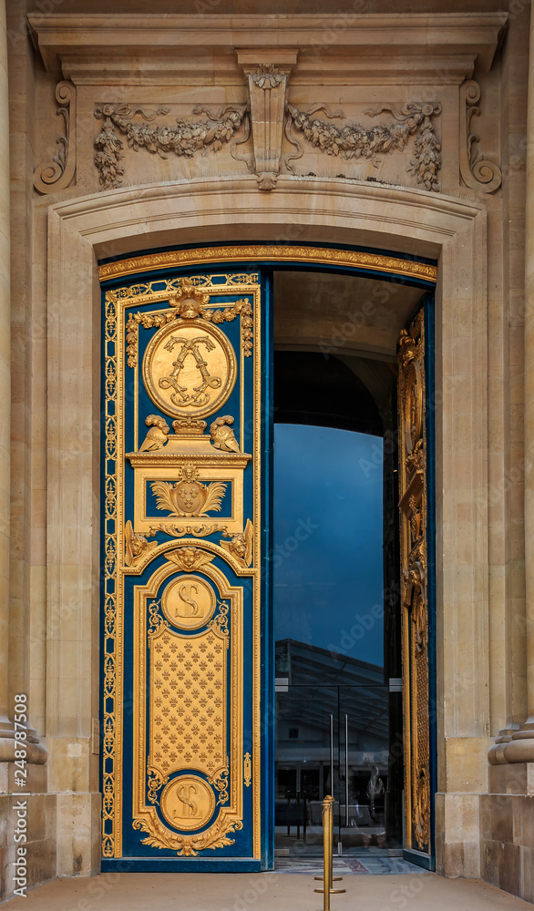 Ornate golden and blue door with fleur de lis pattern at the entrance ...