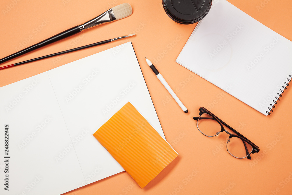 Flat lay feminine workspace on Colored orange office desk. mockup with ...