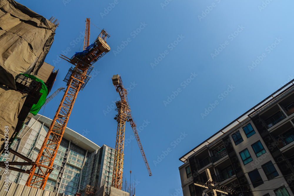 Luffing jib tower crane at condominium construction site over steel ...