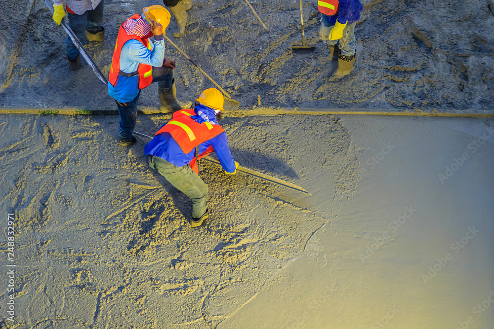 Mason worker leveling concrete with trowels, mason hands spreading ...