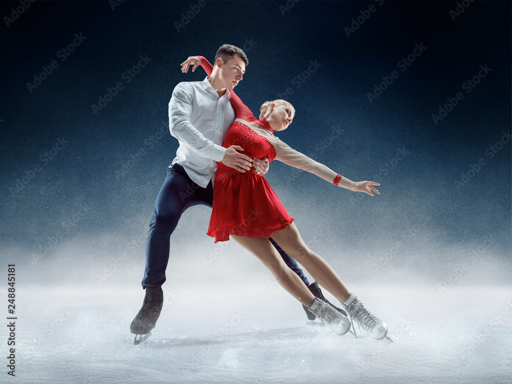 Professional man and woman figure skaters performing show or ...
