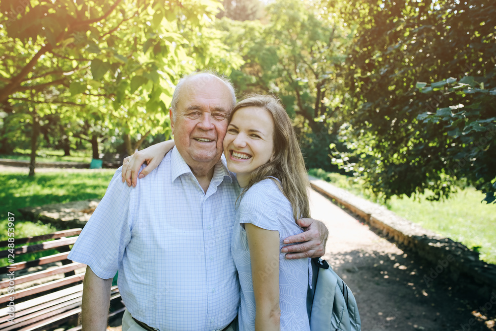 Cute grandpa is hugging his granddaughter. Nice family photo of and old ...