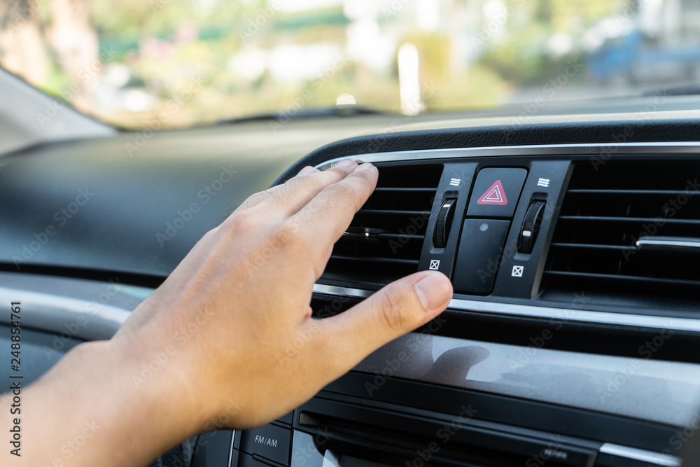 Hand checking the air conditioner in the car, The cooling system in the ...